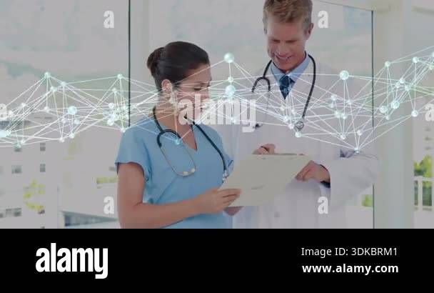 Female nurse scanning chart beside sunlit window initiating male doctor ...