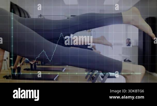Pilates class performing leg reps lowering machine sliding feet into ...