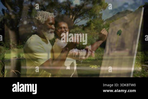 Man placing hand guiding woman painting green leaf on canvas, creating ...