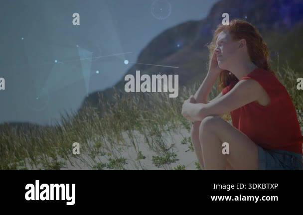 Woman crouching on dune gazing at horizon fading dots forming network ...