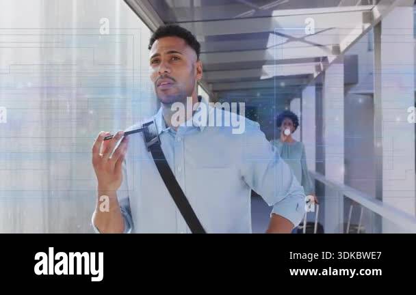 Couple walking airport bridge, man raising smartphone issuing commands ...