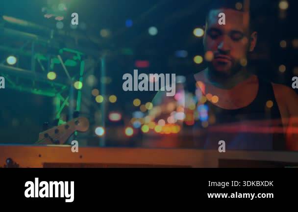Musician pressing keys and adjusting controls, creating pulsing synth ...