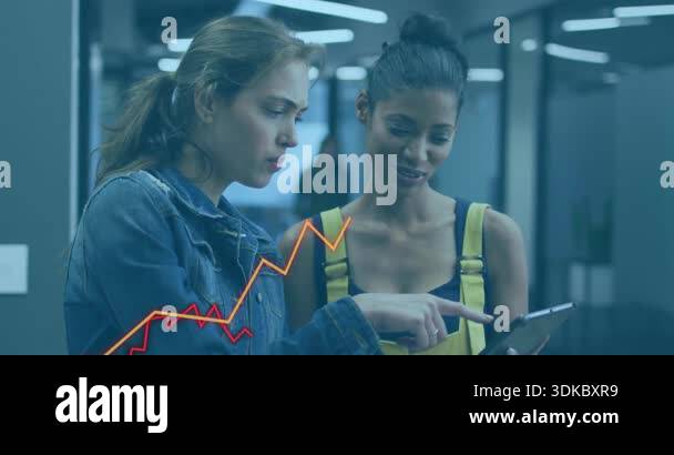 Two office colleagues tapping tablet reviewing business data with ...