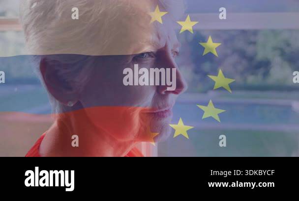 Senior woman standing by window, flag digital overlay emerging ...