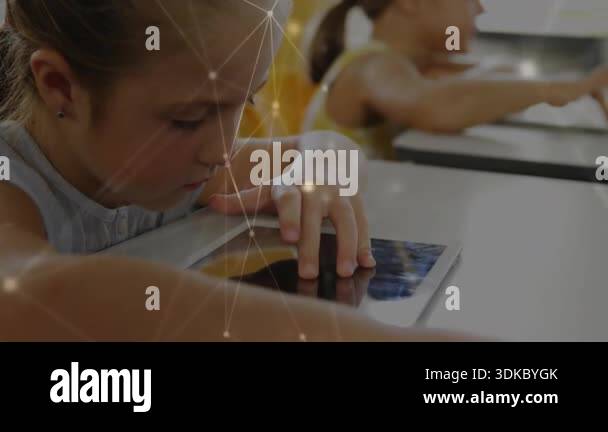 Elementary student tapping tablet screen, activating educational ...