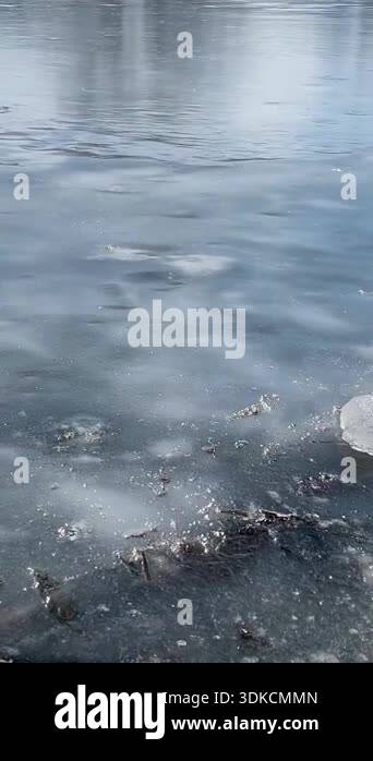 Frozen lake in winter. Pieces of transparent ice near the shore. Winter ...