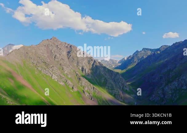 Vast mountain landscape features breathtaking valleys and fluffy clouds ...
