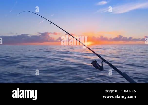 Offshore bottom fishing at sunset, rod on boat over calm sea, golden ...