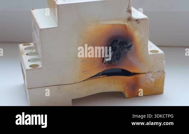 Burnt electrical relay with melted housing and visible overheating ...