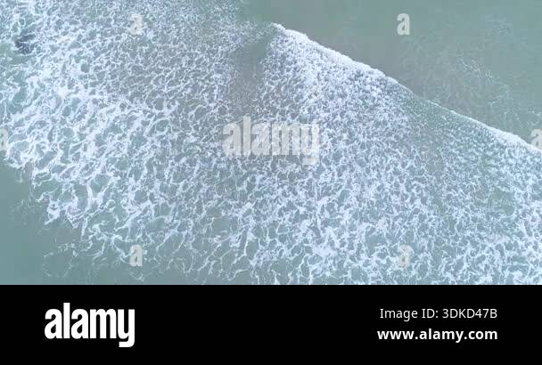 A relaxing and mesmerizing background of the sea surf creating a ...