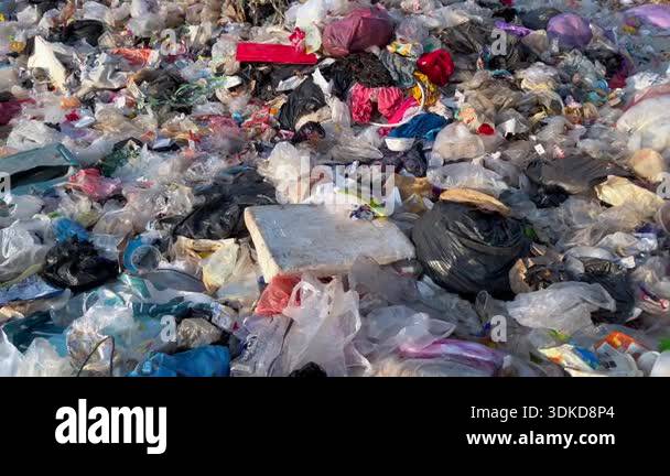 massive landfill filled with plastic waste and garbage, showing severe ...