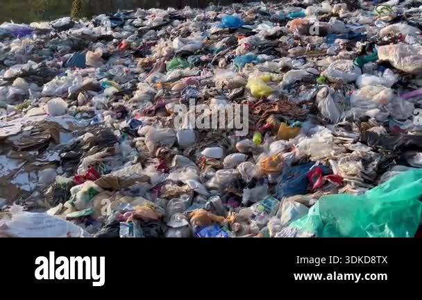 massive landfill filled with plastic waste and garbage, showing severe ...