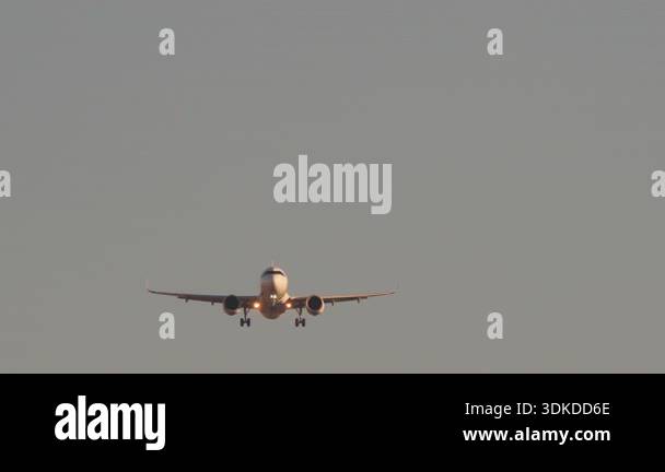 Telephoto video shows a passenger airplane on final approach. The ...