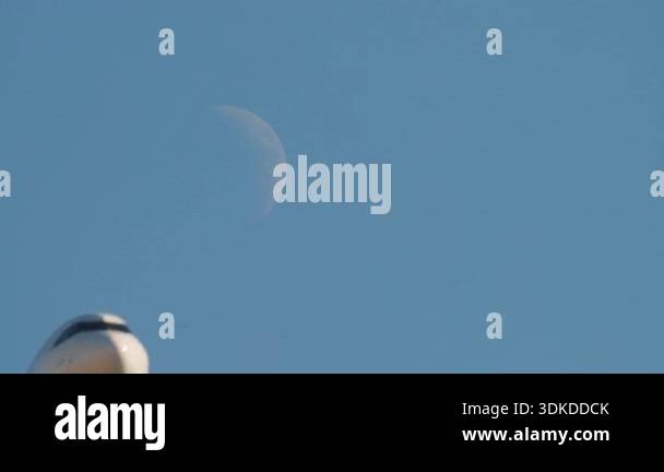 Video starts on a faint crescent moon in a hazy blue sky. Cuts to a low ...