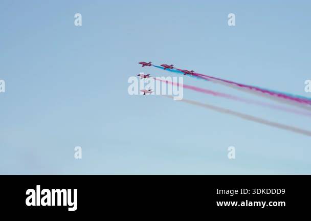 Video footage of an aerobatic jet team in red aircraft performing a ...