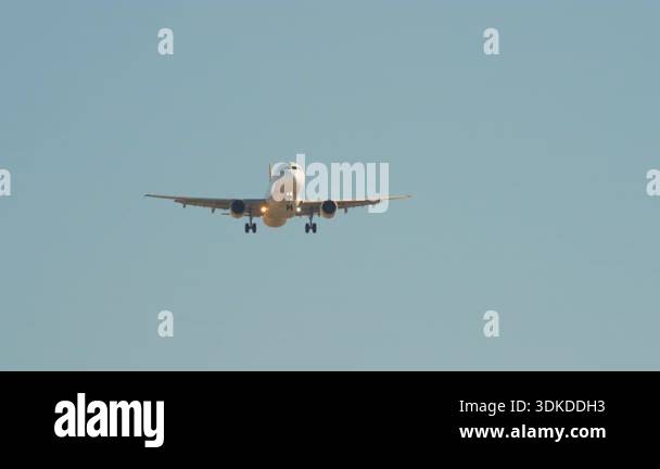 Low-angle video of a commercial airplane on final approach. The ...