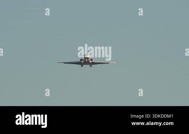 A private business jet on final approach for landing, flying directly ...