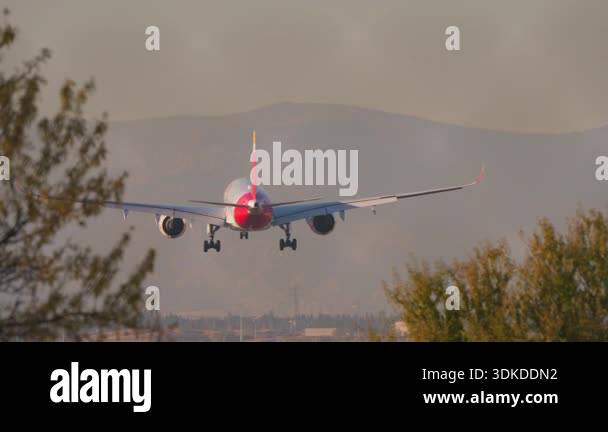 Cinematic footage of a passenger jets final approach and touchdown. The ...