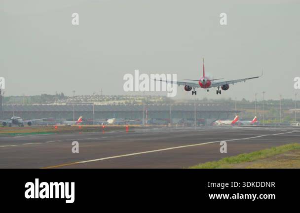 Video footage shows a passenger airplane on final approach, touching ...