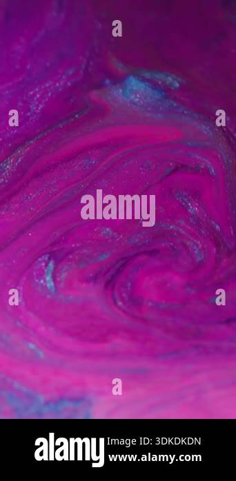 Vertical video. Liquid mix. Flowing ink. Defocused purple pink blue ...
