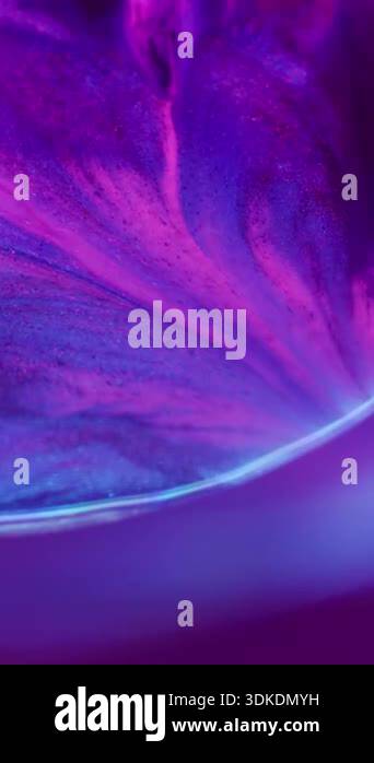 Vertical video. Neon flow. Spill particles. Defocused pink blue purple ...
