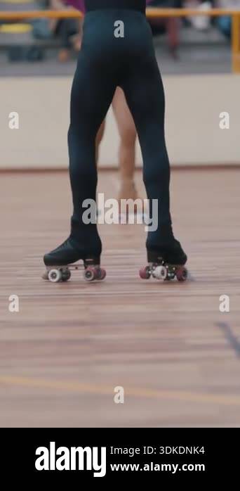 Graceful artistic roller skaters performing a synchronized dance ...