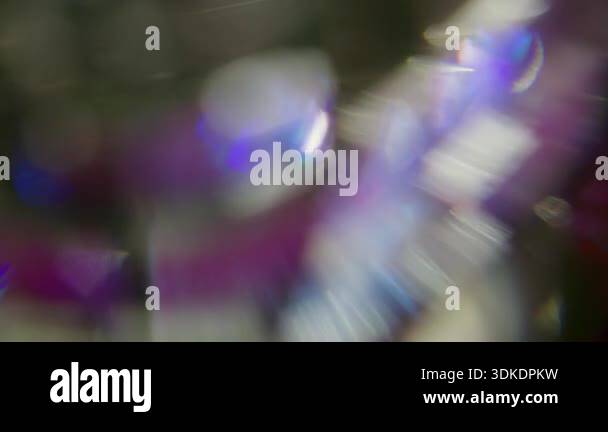 Prism lens defocused. Round glow. Purple blue white light circle rotate ...