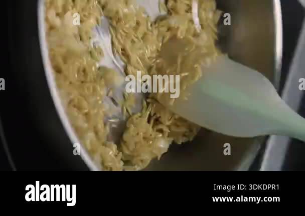 Vertical video. Stirring rice. Cooking asian food. Chef hand adding oil ...