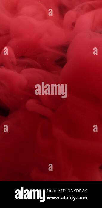 Vertical video. Red splash. Ink water. Defocused bright color liquid ...
