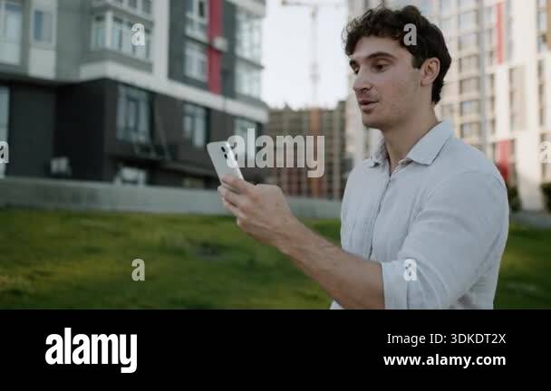 Caucasian business man talking video call holding mobile phone going ...