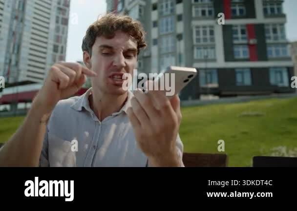 Furious Caucasian business man recording audio message arguing yelling ...