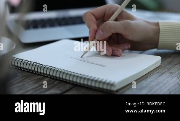 Woman drawing sketch at wooden table, closeup Stock Video Footage - Alamy