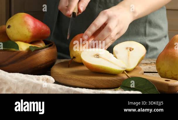 Woman cutting fresh pears at wooden table, closeup Stock Video Footage ...