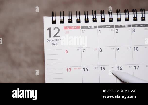 Close-up of December 2026 calendar page with pen pointing at date ...