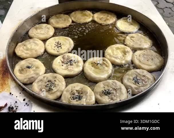 Chinese meat bread fried in a pan are thin and large, which have gone ...
