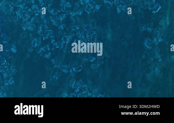 Drone top-down view of water surface during extreme winter cold ...