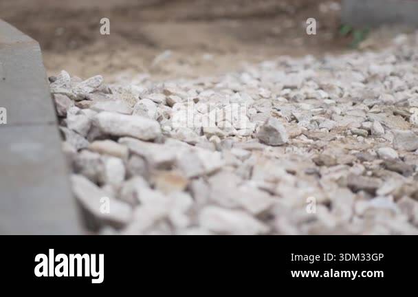 Crushed decorative stone fills space near concrete border. Detailed ...
