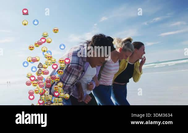 Four women linking arms stepping on beach, launching social media ...