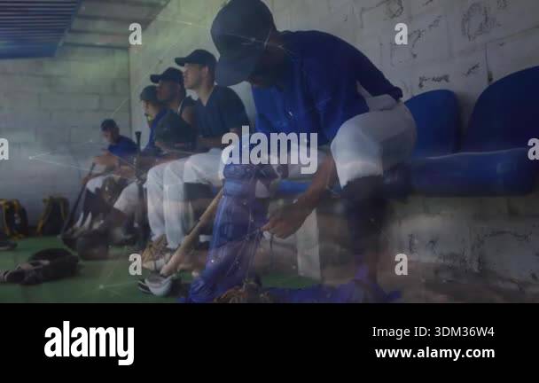 Baseball catcher strapping shin guard as coach arrives, teammates ...