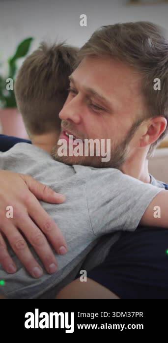Animation of shapes over caucasian father and son embracing. Global ...