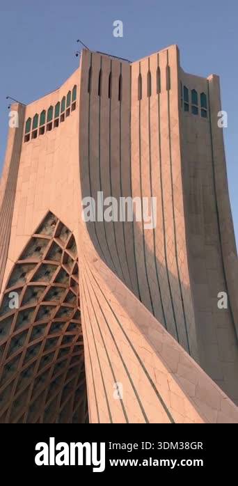 Tilt shot of the Azadi Tower in Tehran, showing modern Persian ...