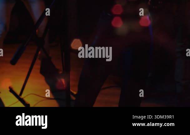 Camera pulling back revealing singer gripping vintage mic singing for ...