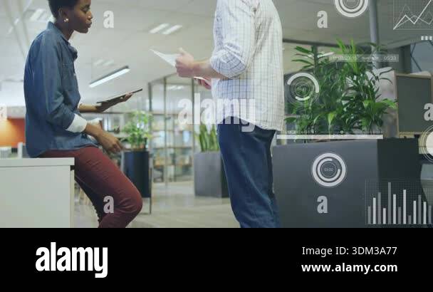 Man pointing charts and guiding woman tapping tablet during business ...