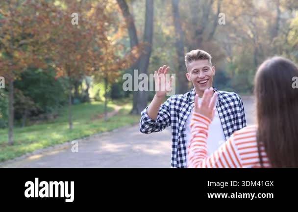 Man waving goodbye to his friend in park Stock Video Footage - Alamy