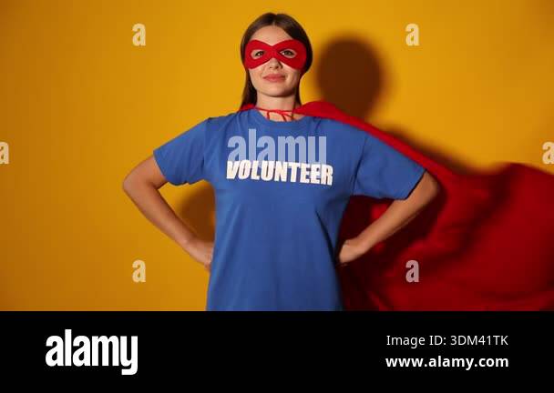 Volunteer wearing superhero costume on yellow background Stock Video ...