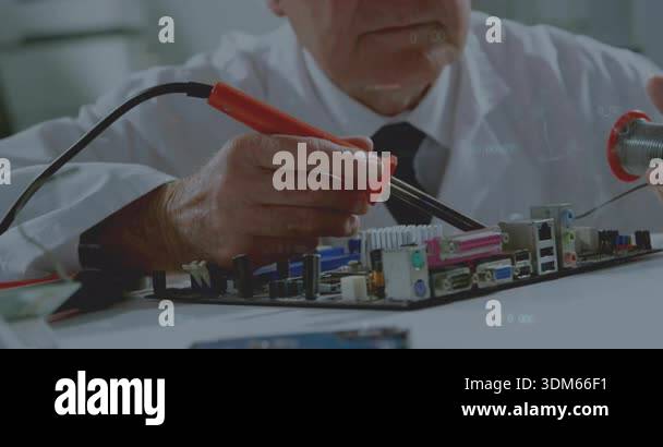 Senior male engineer probing board contacts and checking solder wire ...