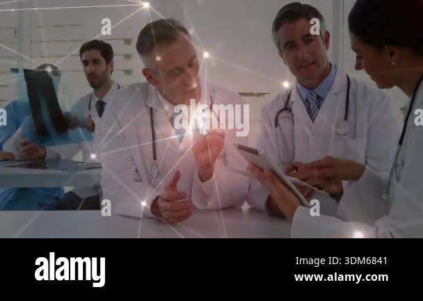 Lead physician tapping tablet and pointing chart while medical team ...