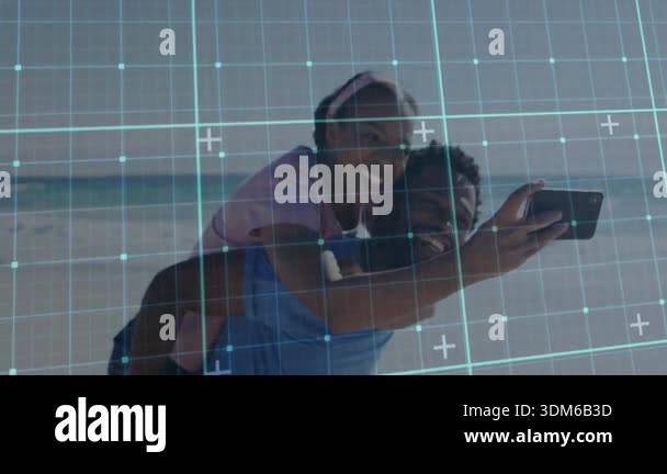 Couple walking on beach with grid overlay, woman stretching phone arm ...