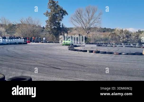 Green car drifting around tire track Stock Video Footage - Alamy