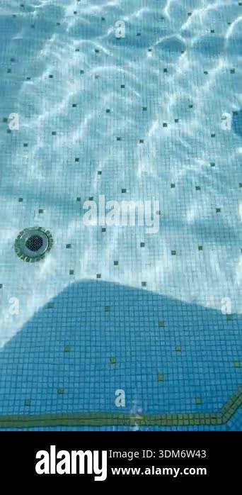 Underwater view of a clean, tiled swimming pool with turquoise blue ...